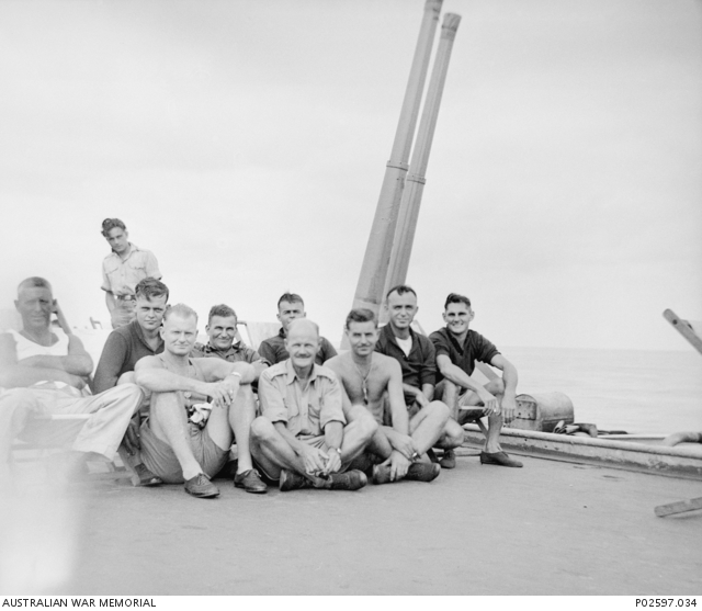 Informal group portrait of former Prisoners of War (POWs) on the deck ...