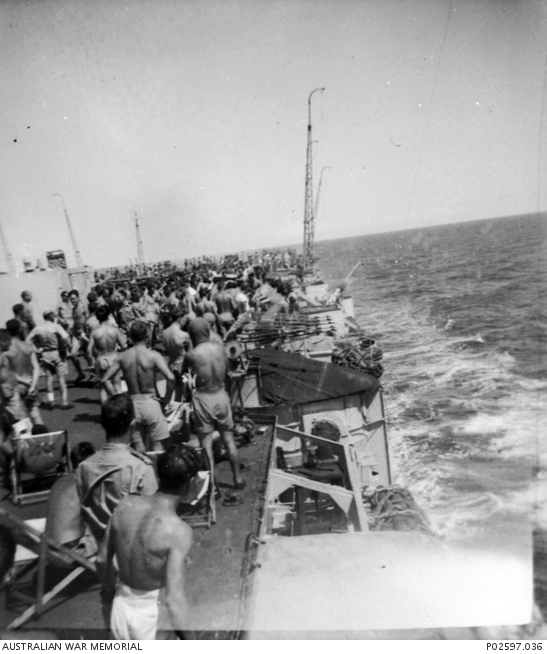 Former Prisoners of War (POWs) mill around on the flight deck of HMS ...
