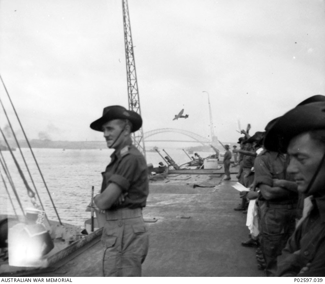 Lieutenant Johnny Fuller stands in front of former Prisoners of War ...