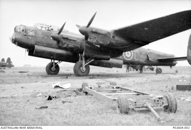 The aftermath of an exploded bomb with Lancaster bomber aircraft C ...