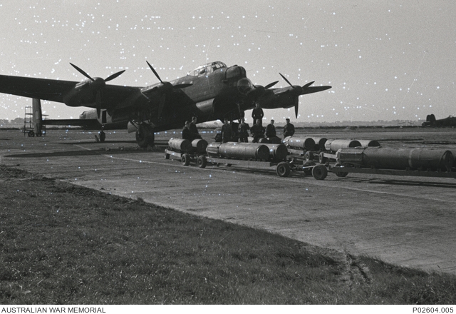 Sea mines on bomb trolleys ready to be loaded into a Lancaster bomber ...
