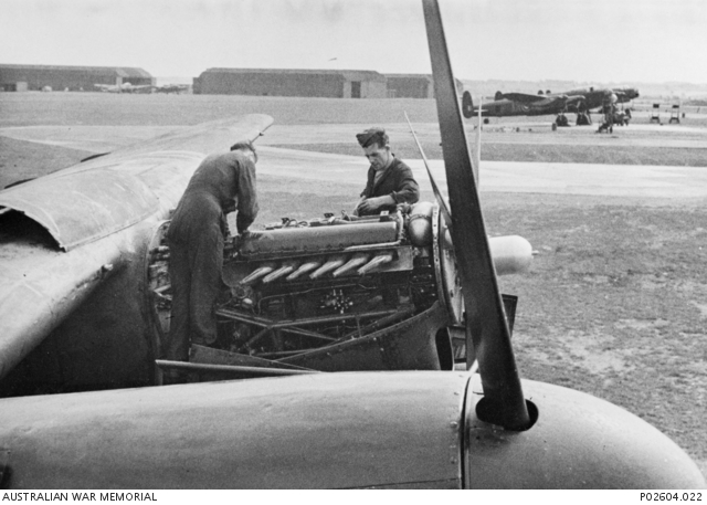 Two unidentified ground crew of 460 Squadron RAAF servicing an engine ...