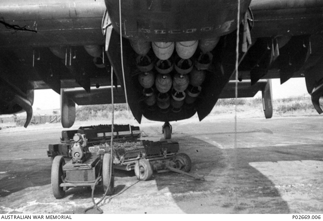 England. c 1944. Bombs loaded into the belly of `Tommy the Tourist', a ...