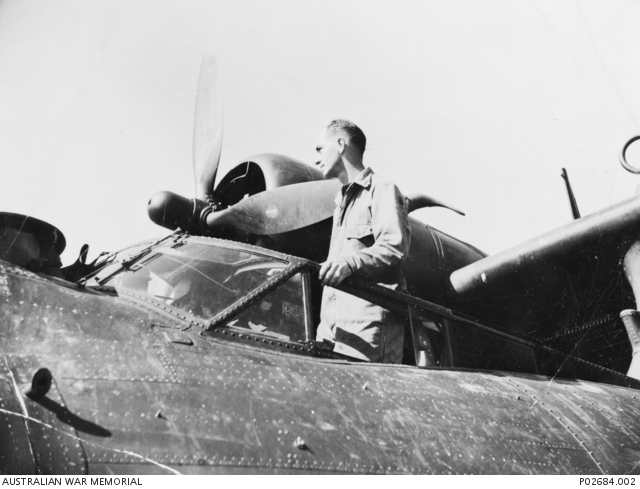 Informal portrait of 6047 Flight Sergeant Ronald Arthur Pitman, an RAAF fitter, stands in the ...