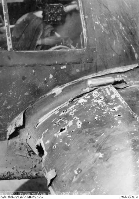 View of the damaged port side wing root and the cockpit of a 455 ...
