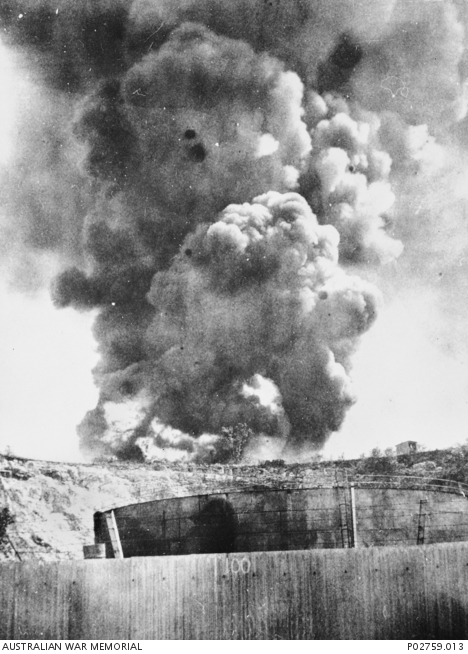 Smoke billowing from an oil tank on the waterfront burning after a ...