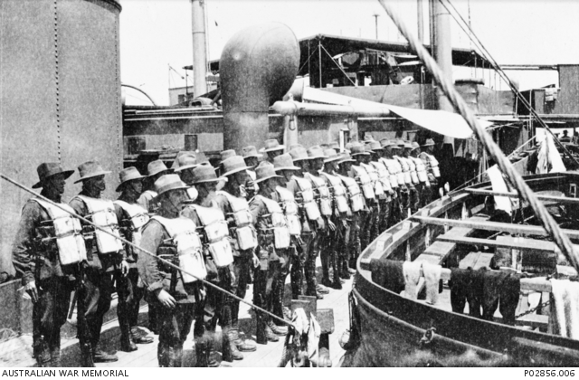 Troops wearing life jackets and holding rifles lined up on drill on ...