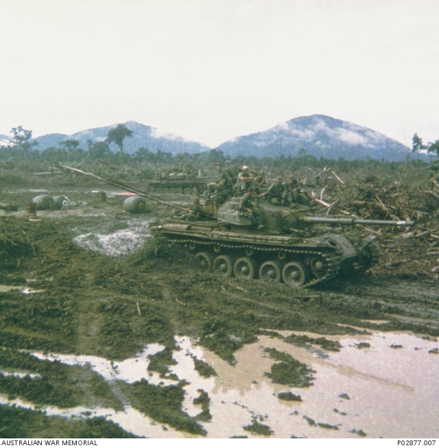 A Centurion MkV/1 tank driving through the mud at Fire Support Base ...