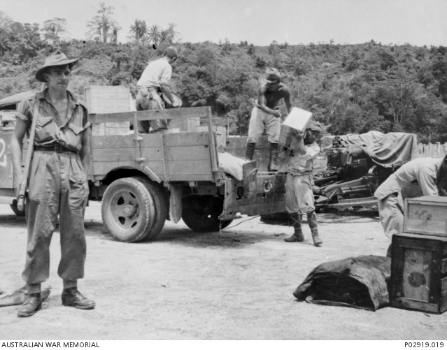 Sandakan, North Borneo. 18 October 1945. Japanese troops, supervised by ...