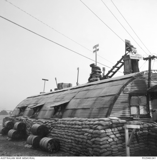 Corrugated iron Nissen hut orderly room of 77 Squadron RAAF. Note the ...