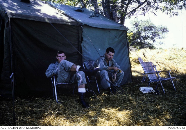 Two members of 9 Squadron RAAF relax outside the standby tent at a ...