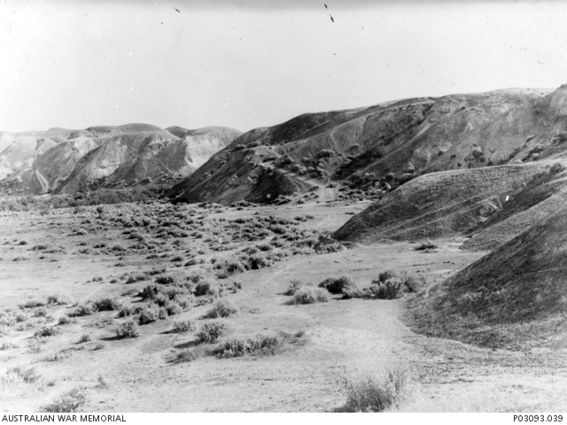 The view of mountains and the valley floor surrounding a small camp ...
