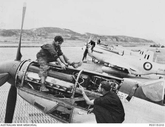 Two unidentified airmen from 77 Squadron RAAF maintain one of their ...