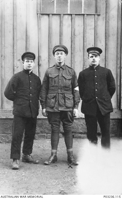 Outdoor portrait of one Australian and two English Prisoners of War ...