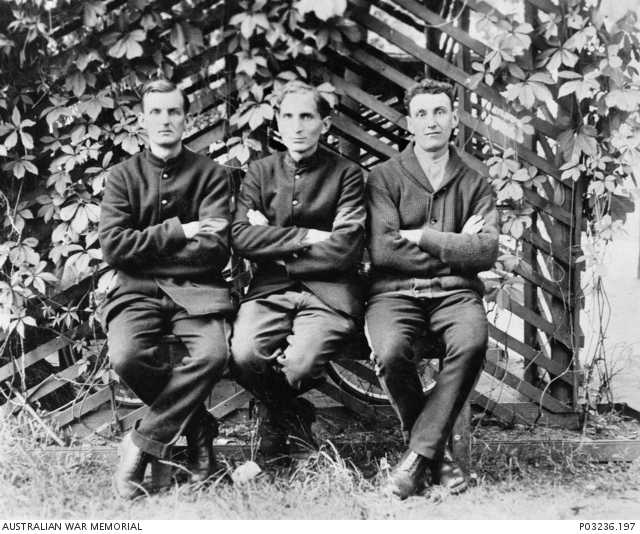 Outdoor portrait of three Allied Prisoners of War (POW) at German POW ...