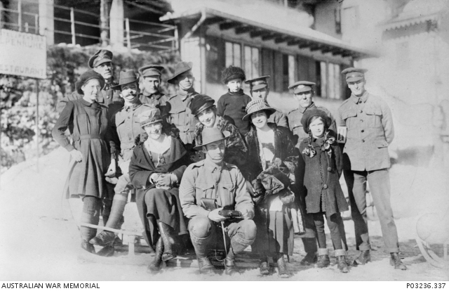 Group portrait of transferred Prisoners of War (POW) with women and ...