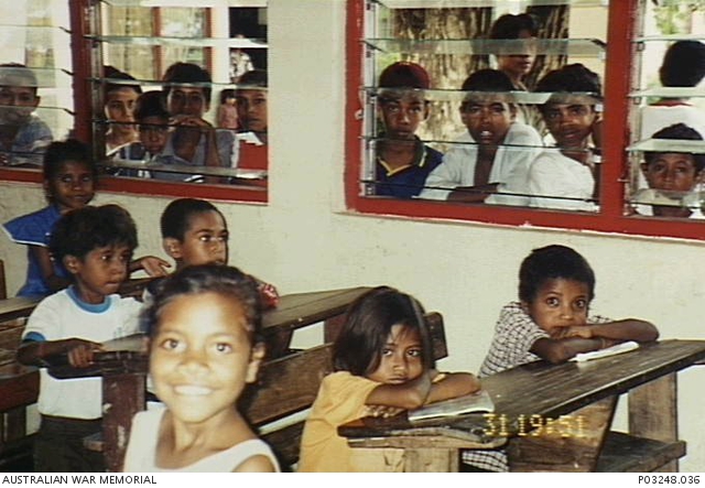 Dili, East Timor. 20 December 1999. Young Timorese children sitting at ...