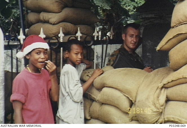 Dili, East Timor. 21 December 1999. Two Timorese children, one wearing ...