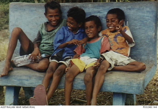 Dili, East Timor. 28 December 1999. Four Timorese children sitting ...