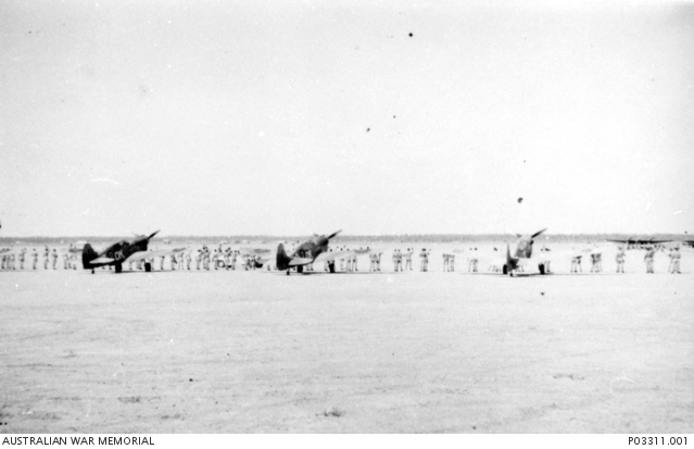 Men of 450 Squadron, RAAF, lined up in front of their Curtiss P40 ...