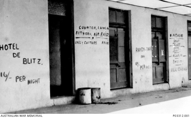 Graffiti on the exterior wall of the Don Hotel after first Japanese air ...