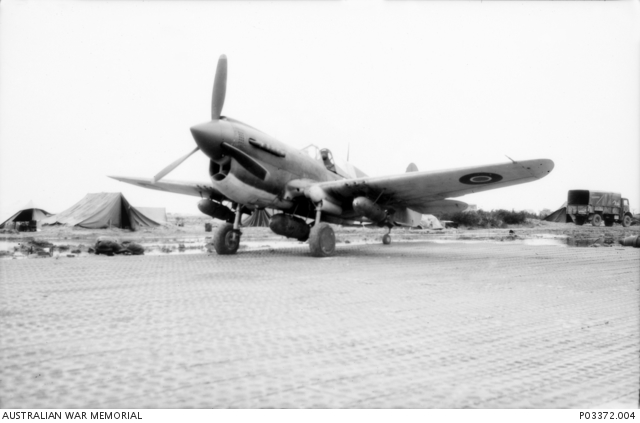 A Kittyhawk aircraft of 450 Squadron RAAF with a 500 lb bomb under the ...