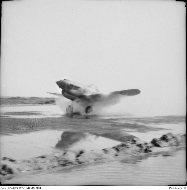 An aircraft of 450 (Kittyhawk) Squadron RAAF taking off from an ...