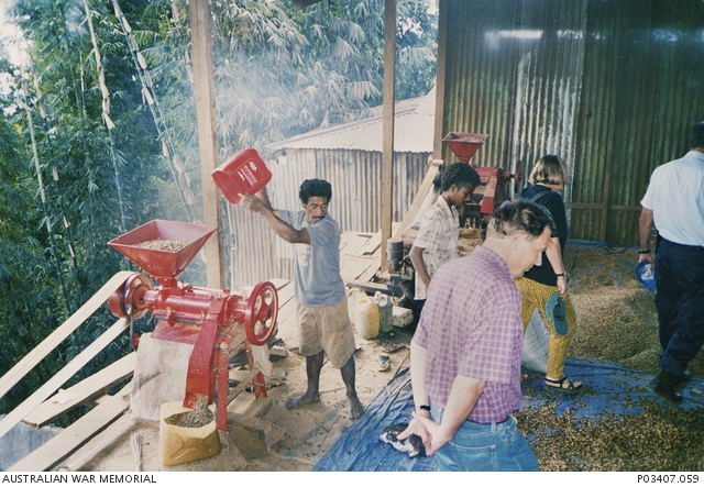 Members of the United Nations Mission East Timor (UNAMET) walking past ...