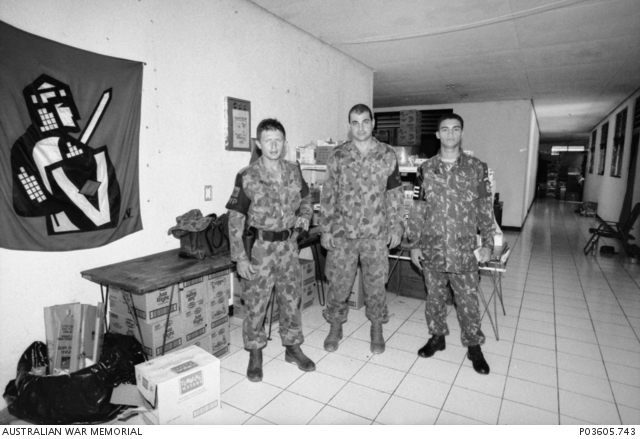 Informal group portrait of three members of the military police of the ...