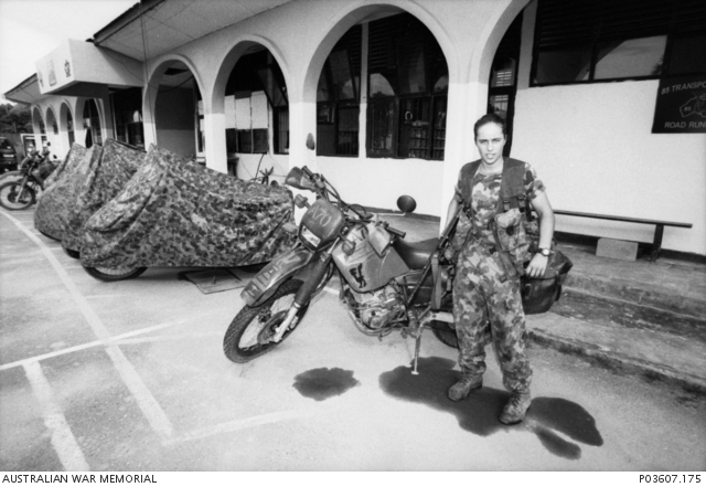 Corporal Hart, 15th Transport Squadron, stands armed with her rifle and ...