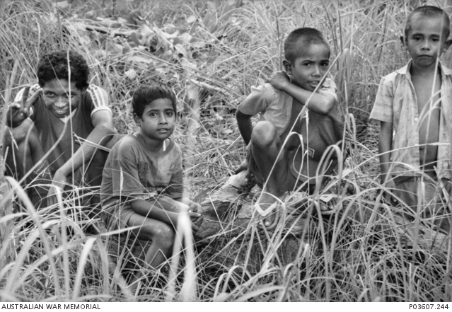 Four East Timorese children at an exhumation site. Members of an ...