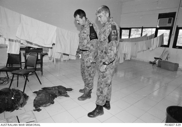 At the morgue, Sergeant Gil Edwards, RAAF Security Police (left), and ...