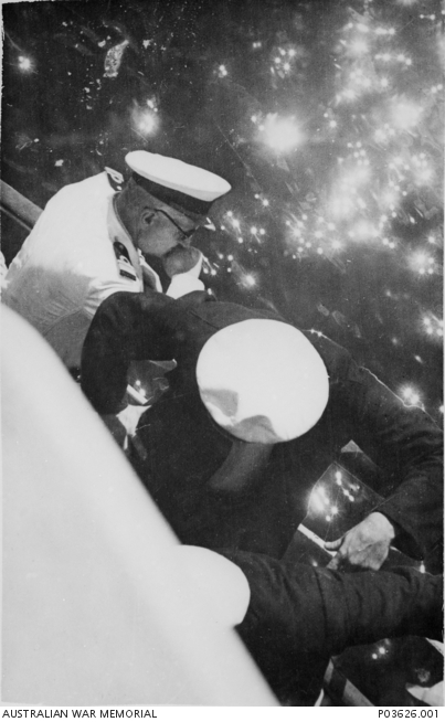 Two unidentified men on the Italian motor vessel Romolo. The man on the ...