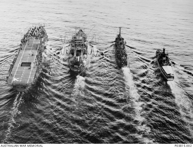 Stern view of four Allied Navy ships in the ocean off Korea. From left ...
