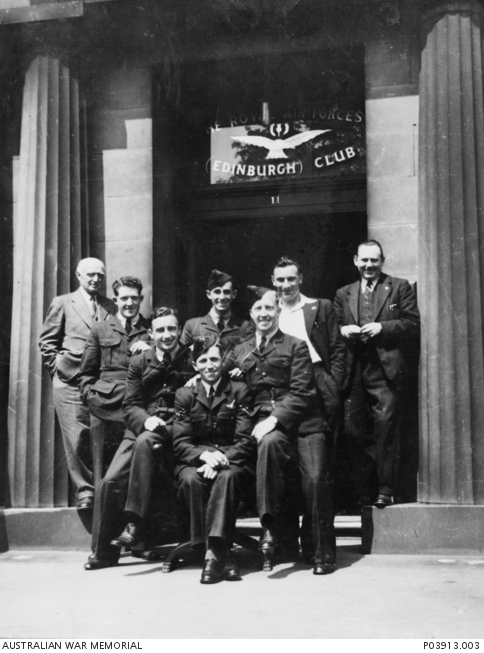 Group portrait of unidentified air crew outside the entrance of the ...