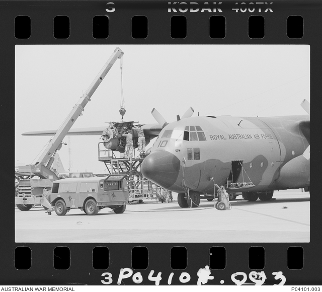 Two ground crew members from 36 Squadron RAAF complete maintenance on ...