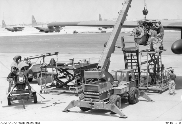 Ground crew members from 36 Squadron RAAF complete maintenance on an ...