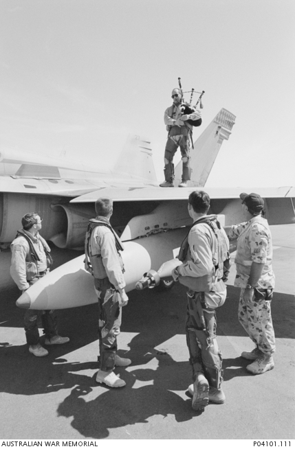 A group of air and ground crew members of 75 Squadron RAAF gather to ...