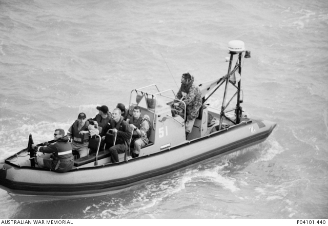 A boarding party in a Rigid-Hulled Inflatable Boat (RHIB) from HMAS ...