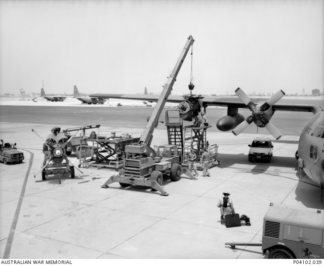 Ground crew members from 36 Squadron RAAF complete maintenance on an ...