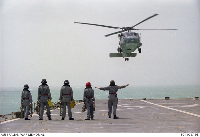 Crew members on the flight deck of HMAS Kanimbla prepare for the ...