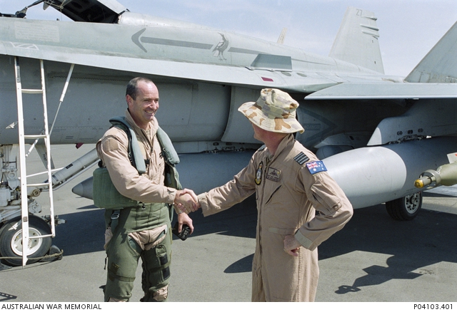 Group Captain William Henman (right) greets Wing Commander Melvin E.G ...