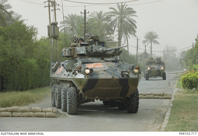 A convoy of two Australian Light Armoured Vehicles (ASLAV) from the 2nd ...