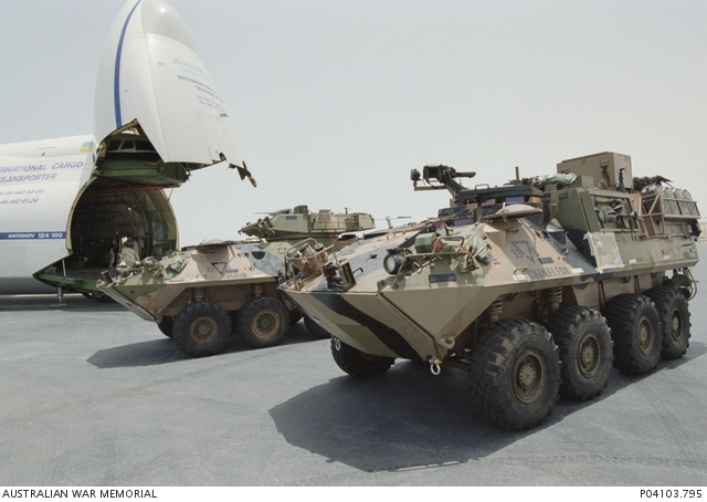 Two Australian Light Armoured Vehicles (ASLAV) sit on the tarmac at ...
