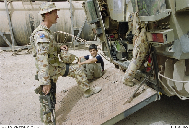 Unidentified members of the 2nd Calvary Regiment enter the rear of an ...