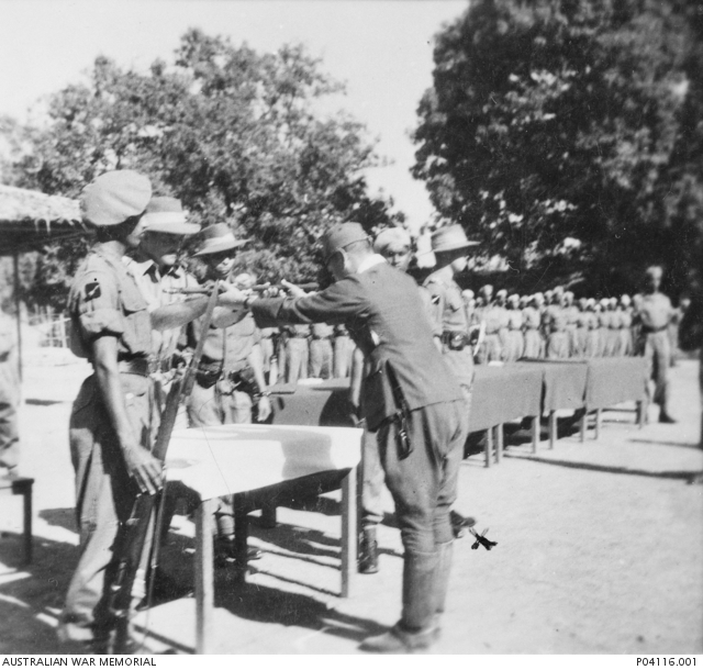 A Japanese Colonel hands over his sword to a British Lieutenant Colonel ...