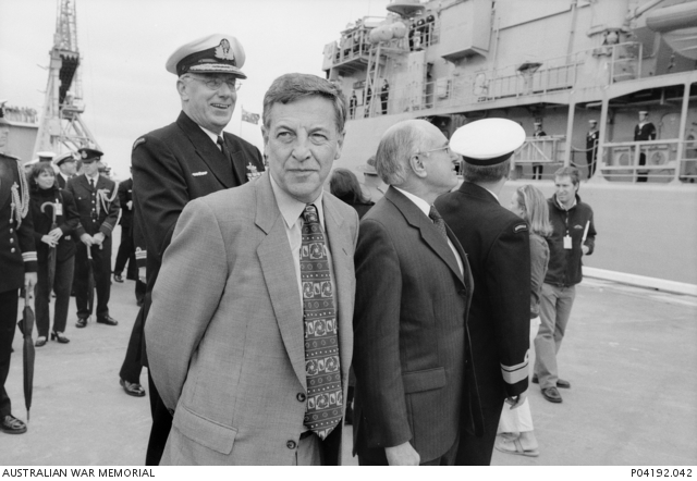 Politicians and senior naval officers watch on the quayside at Victoria ...