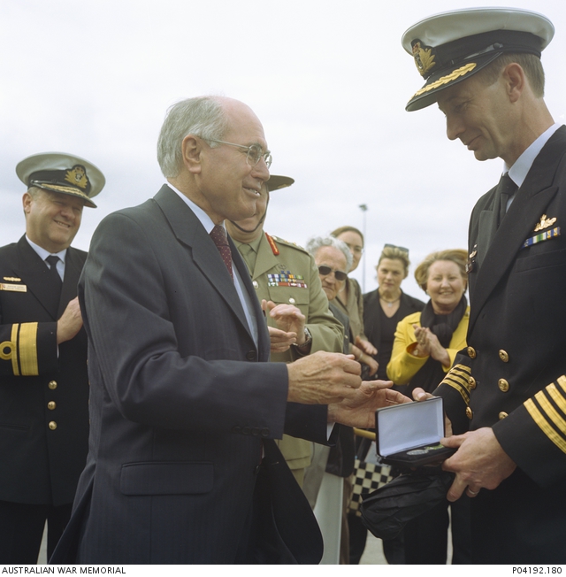 The Prime Minister, John Howard, presents a medal to Captain (Capt ...