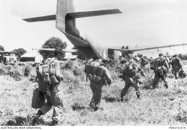Diggers of 5RAR, move to board an RAAF Caribou aircraft to be flown ...