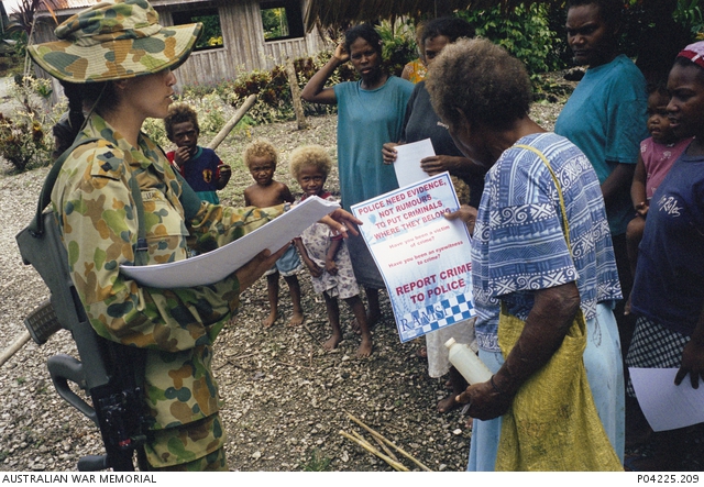 Captain Rachel Leal of 1st Intelligence Battalion discusses a flyer ...
